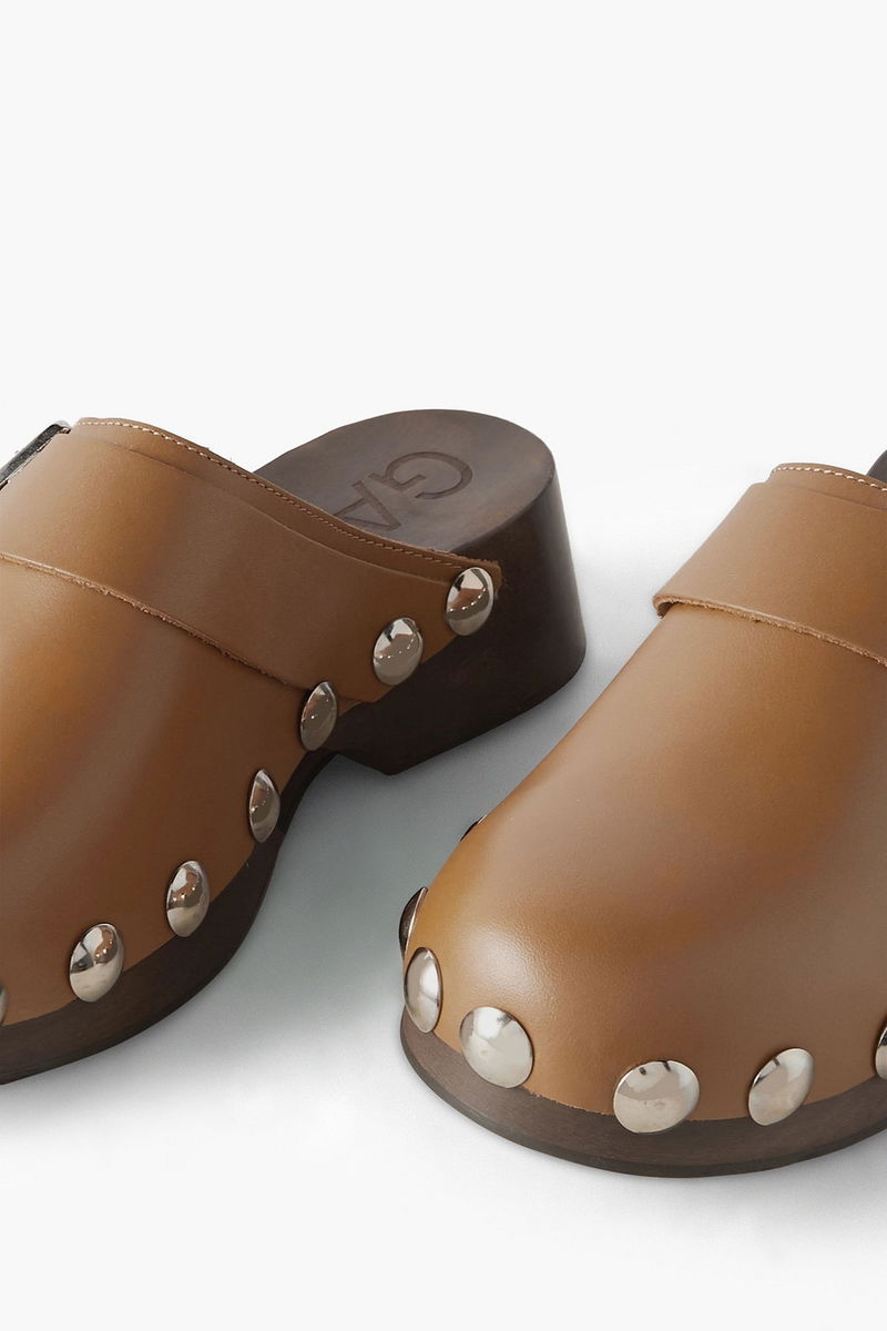 GANNI Studded Buckled Leather Clogs in Brown | endource