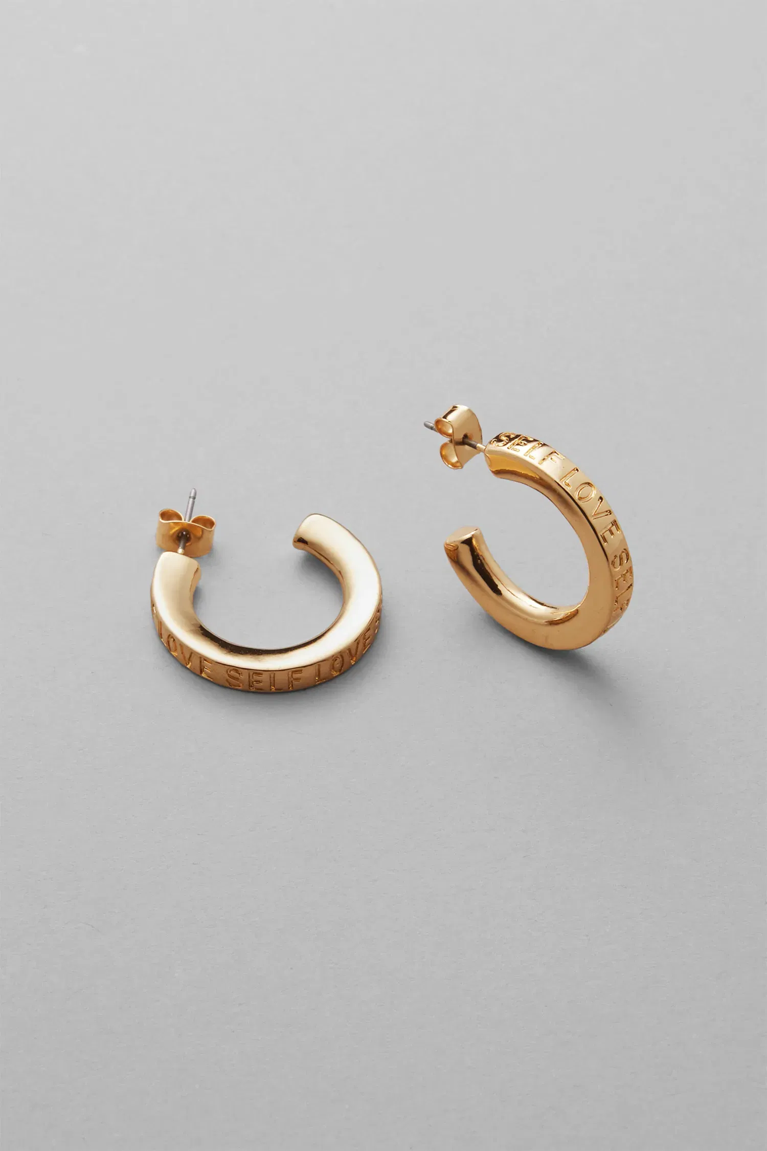 WEEKDAY Text Hoop Earrings in Gold | Endource