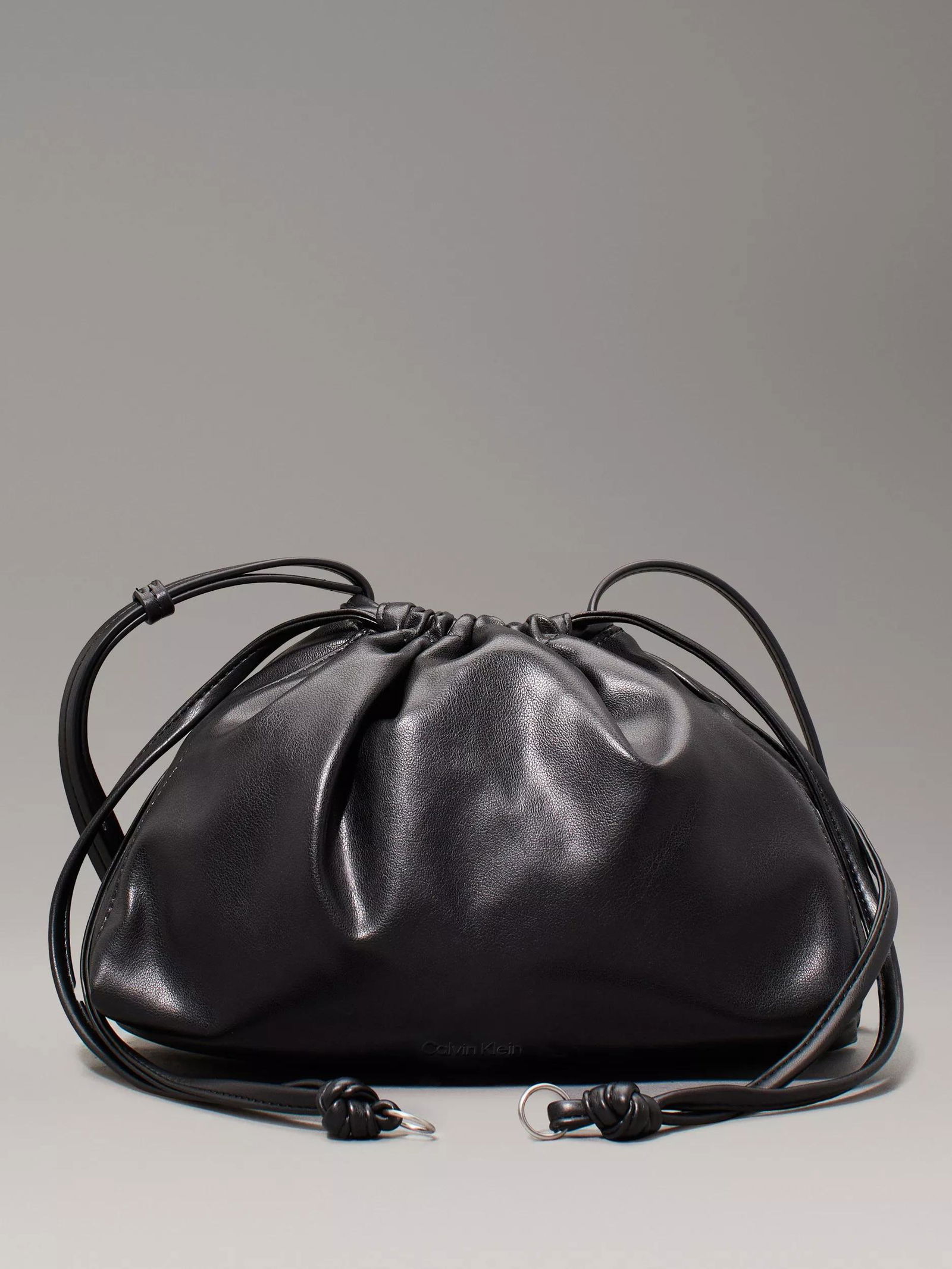 CALVIN KLEIN Faux Leather Drawstring Crossbody Bag in Black | endource